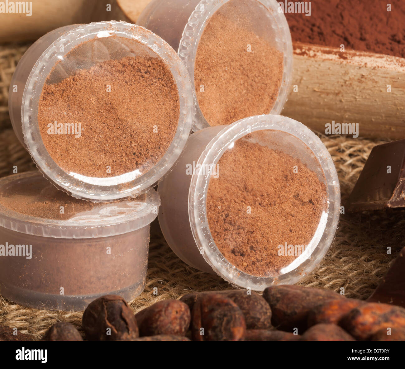 Capsules of chocolate with cocoa powder, cocoa beans and pieces of ...