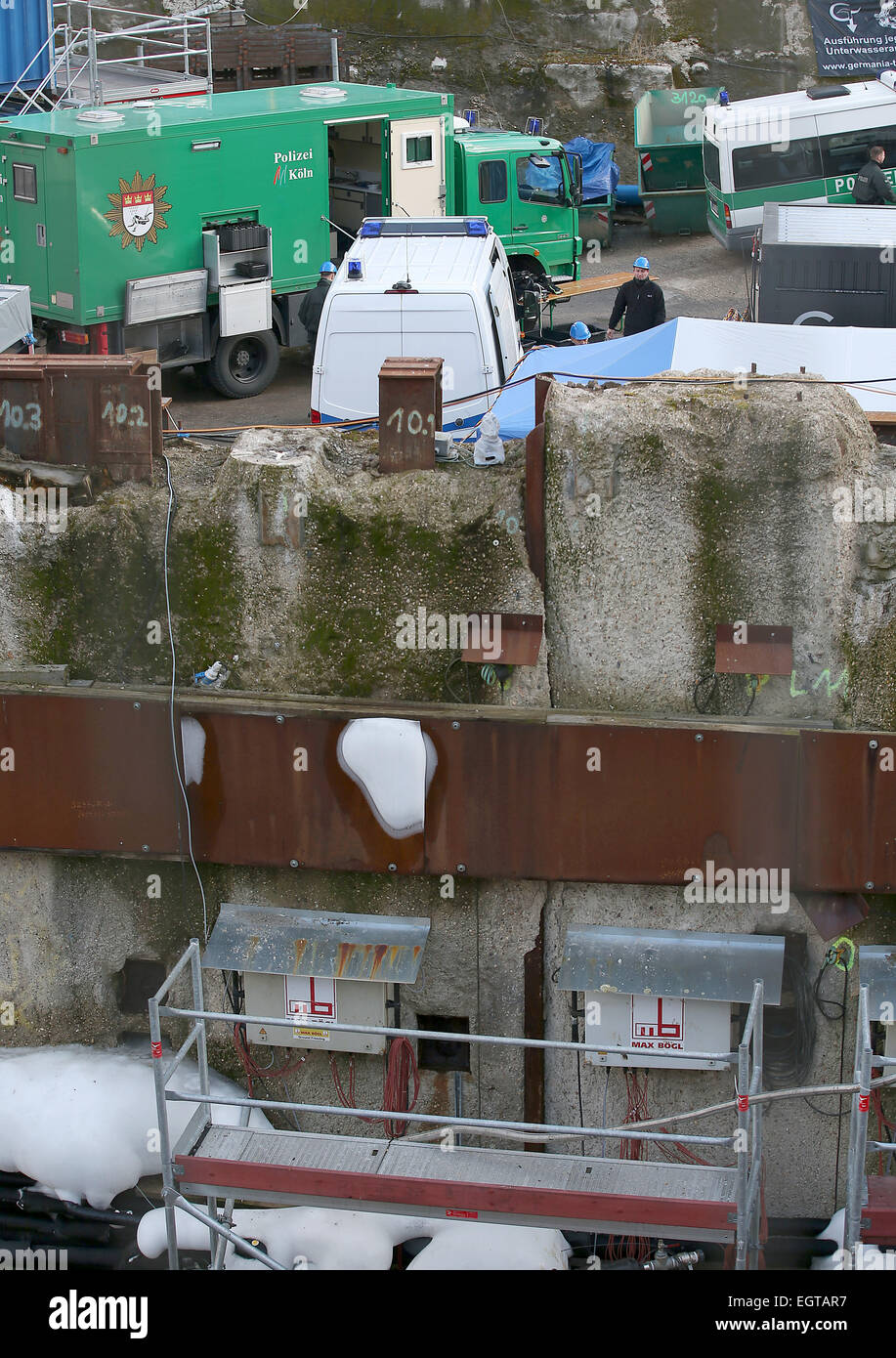 Police officers and engineers work on the sight of the collapse of the ...