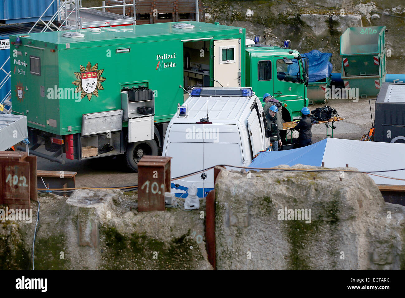 Police officers and engineers work on the sight of the collapse of the ...
