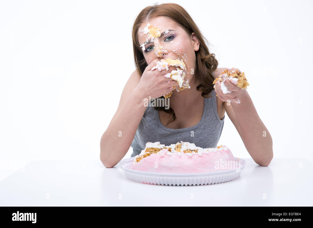 Beautiful woman sitting at the table and eating cake Stock Photo - Alamy