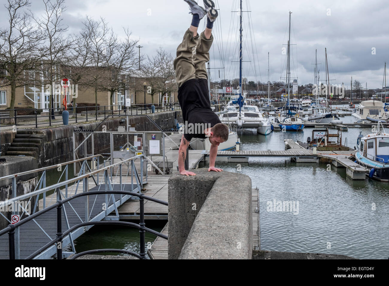 Young man doing Parkour, or Acrobatics using street furniture Stock ...