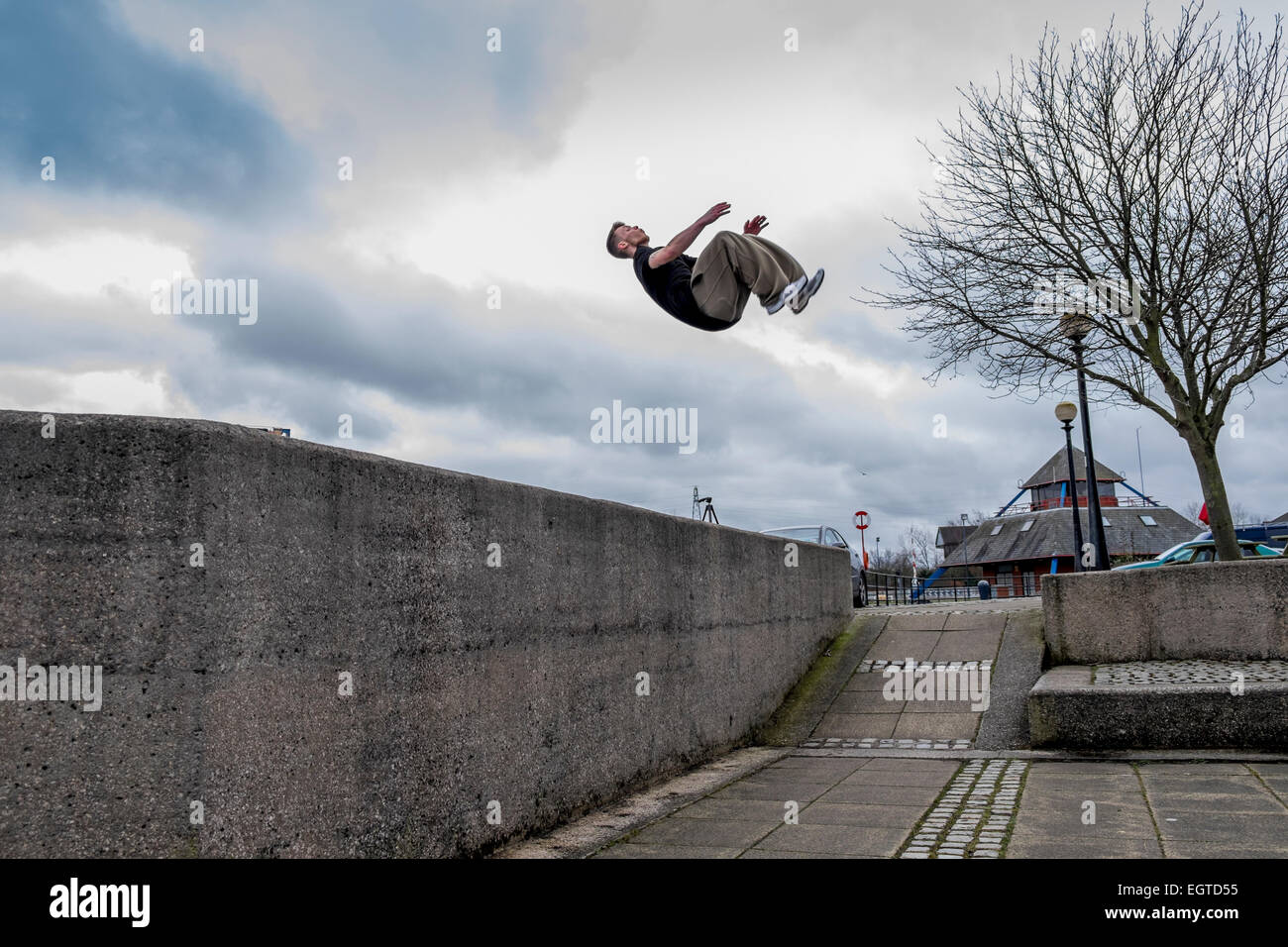 Young man doing Parkour, or Acrobatics using street furniture Stock ...