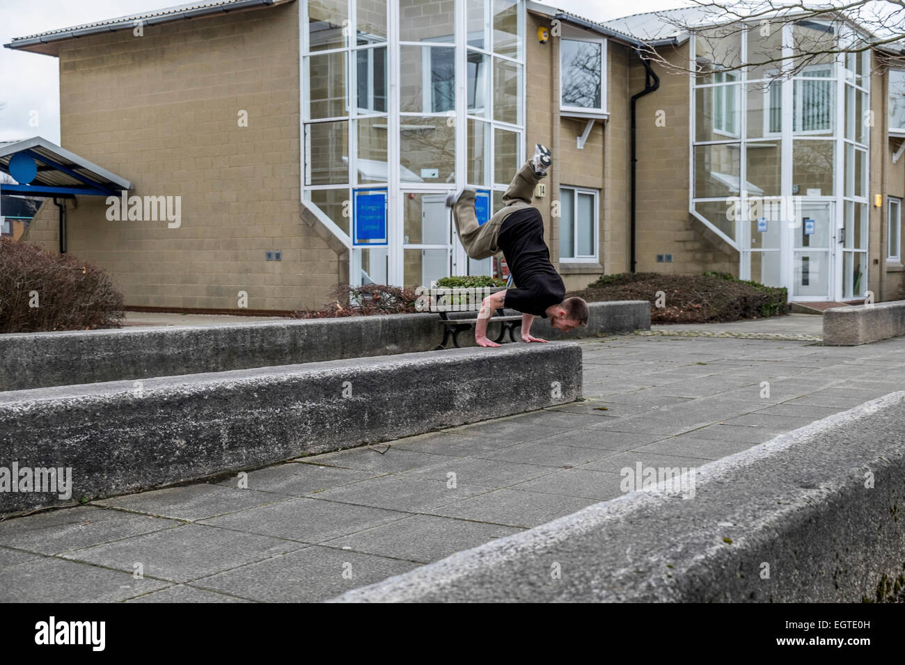 Young man doing Parkour, or Acrobatics using street furniture Stock ...