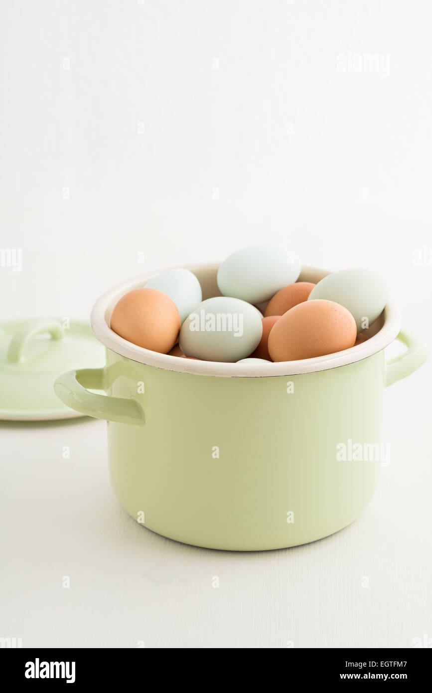 Fresh light green eggs from Easter egger chicken and brown eggs in a ...