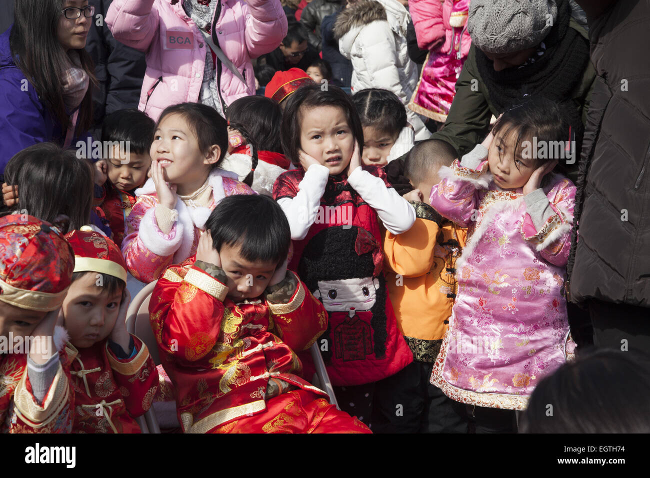 Chinese children in costumes at Chinese New Year celebration hold their ...