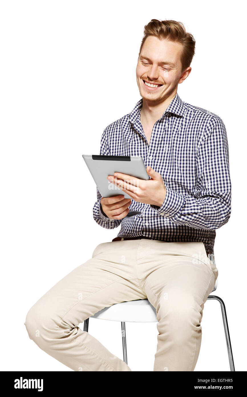 Handsome man smiling to the tablet. Isolated on white background Stock ...