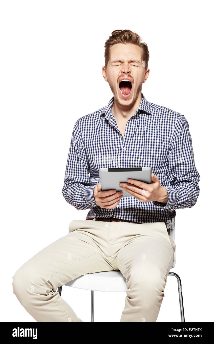 Studio shot of young yawning man. Facial expression Stock Photo - Alamy