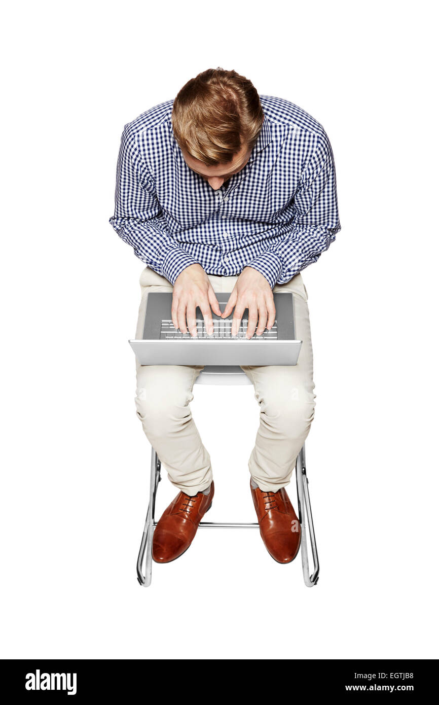 Young man leaning over the keyboard. Isolated on white background Stock ...