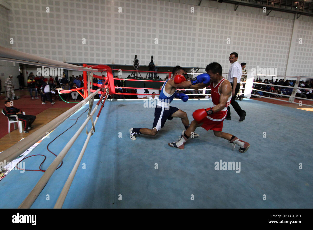 Boxer from Sikkim (red) in action against the Maharashtra (blue) during ...