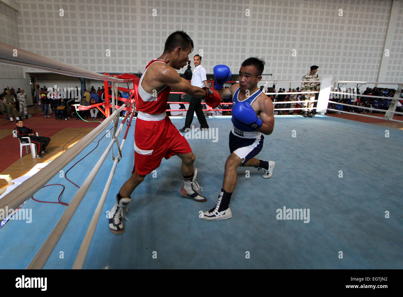 Boxer from Sikkim (red) in action against the Maharashtra (blue) during ...