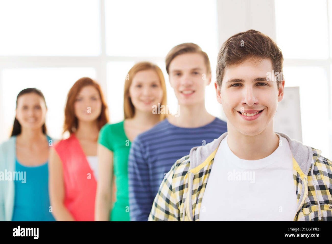 smiling male student with group of classmates Stock Photo - Alamy
