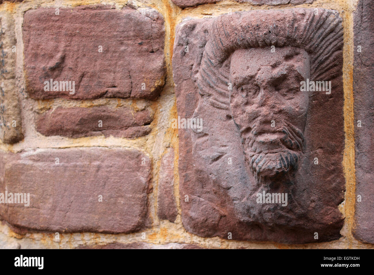 Carving Of A Face In Red Sandstone Stock Photo - Alamy