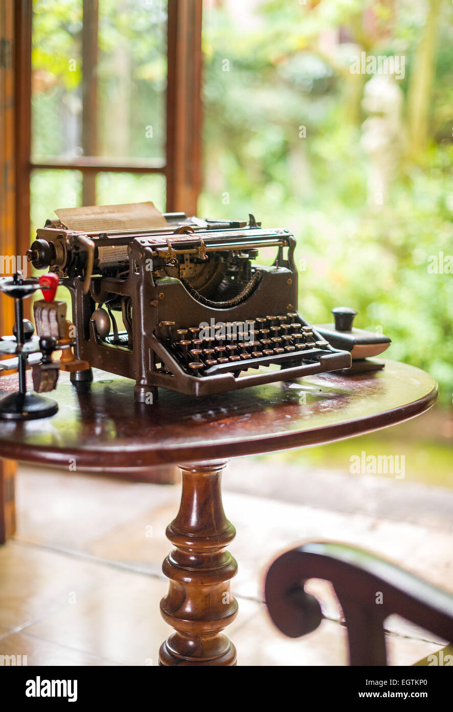 Antique typewriter on table by the window Stock Photo - Alamy