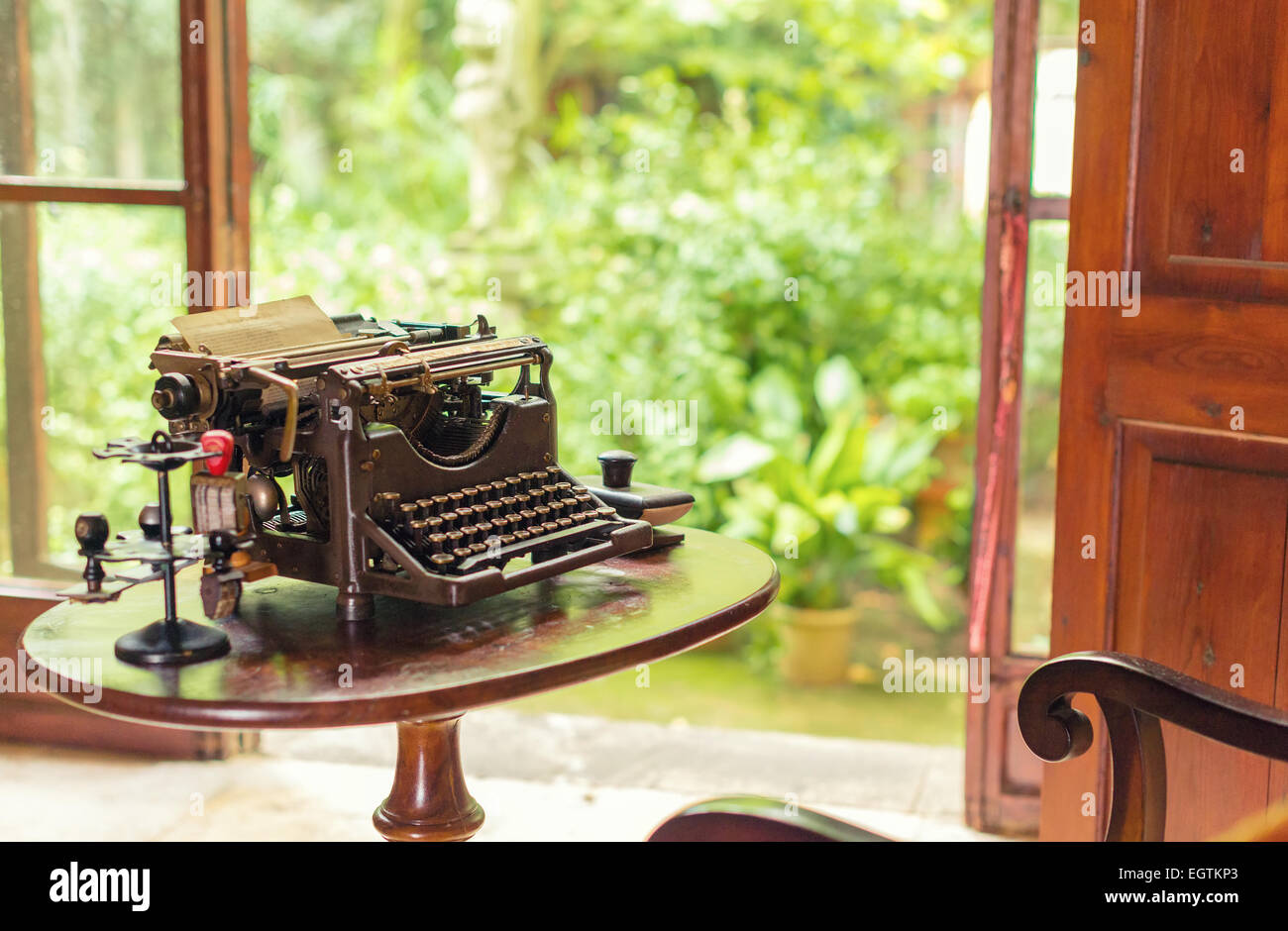 Antique typewriter on table by the window Stock Photo - Alamy