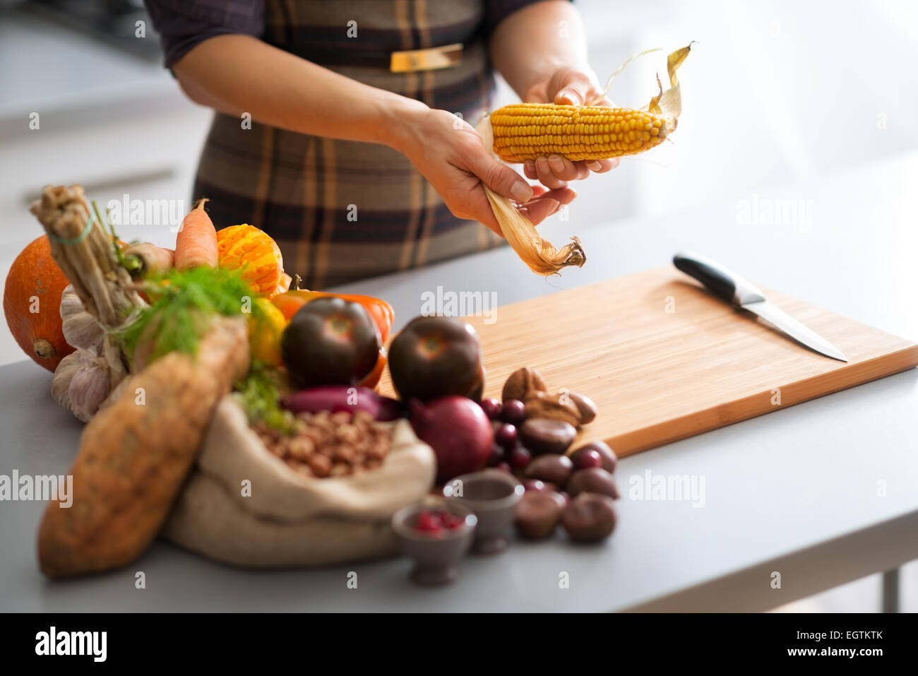 Closeup on young housewife peeling corn Stock Photo - Alamy