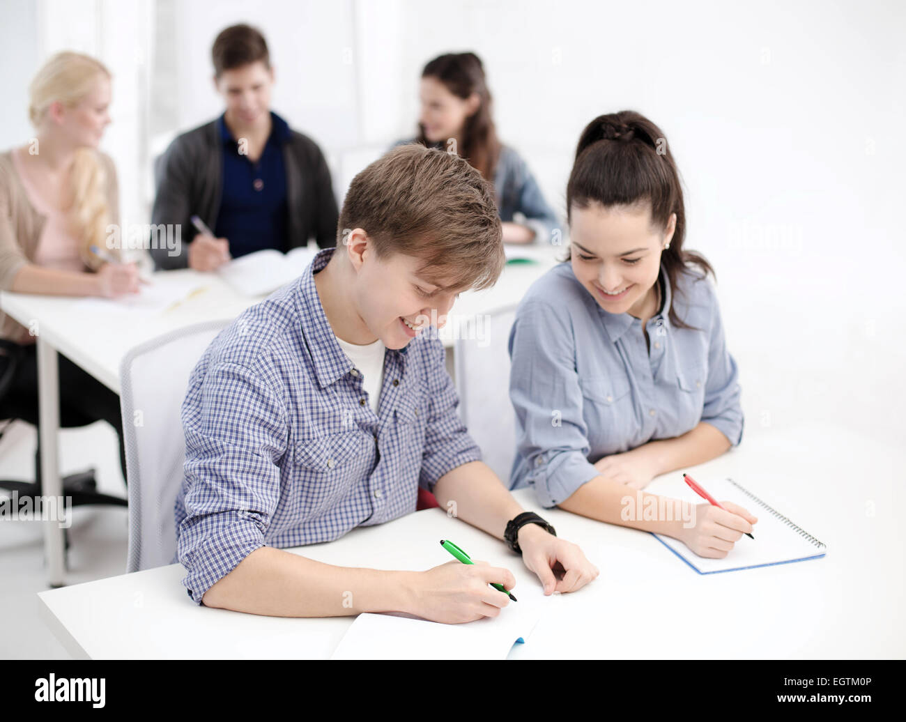 smiling students with notebooks at school Stock Photo - Alamy