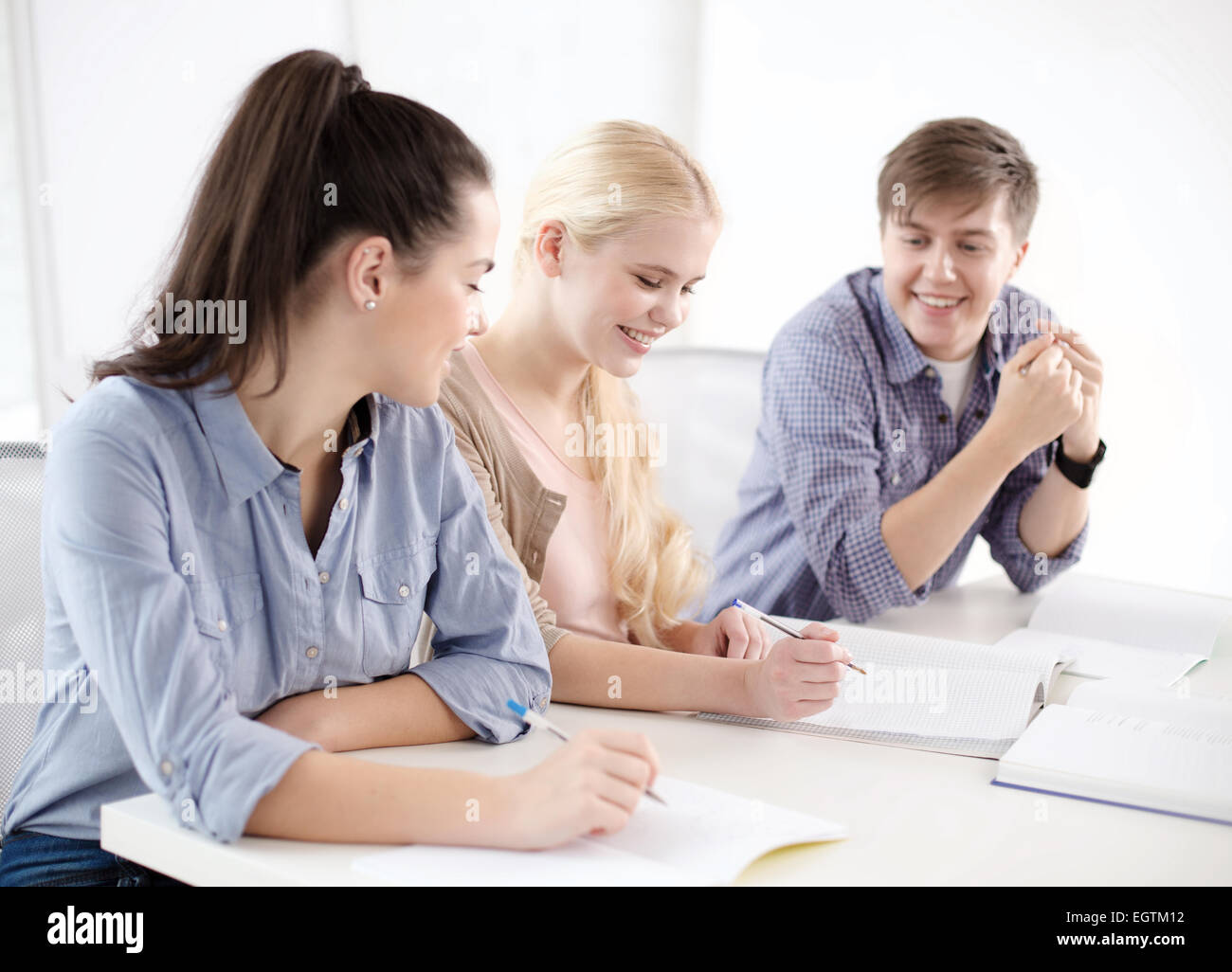 smiling students with notebooks at school Stock Photo - Alamy
