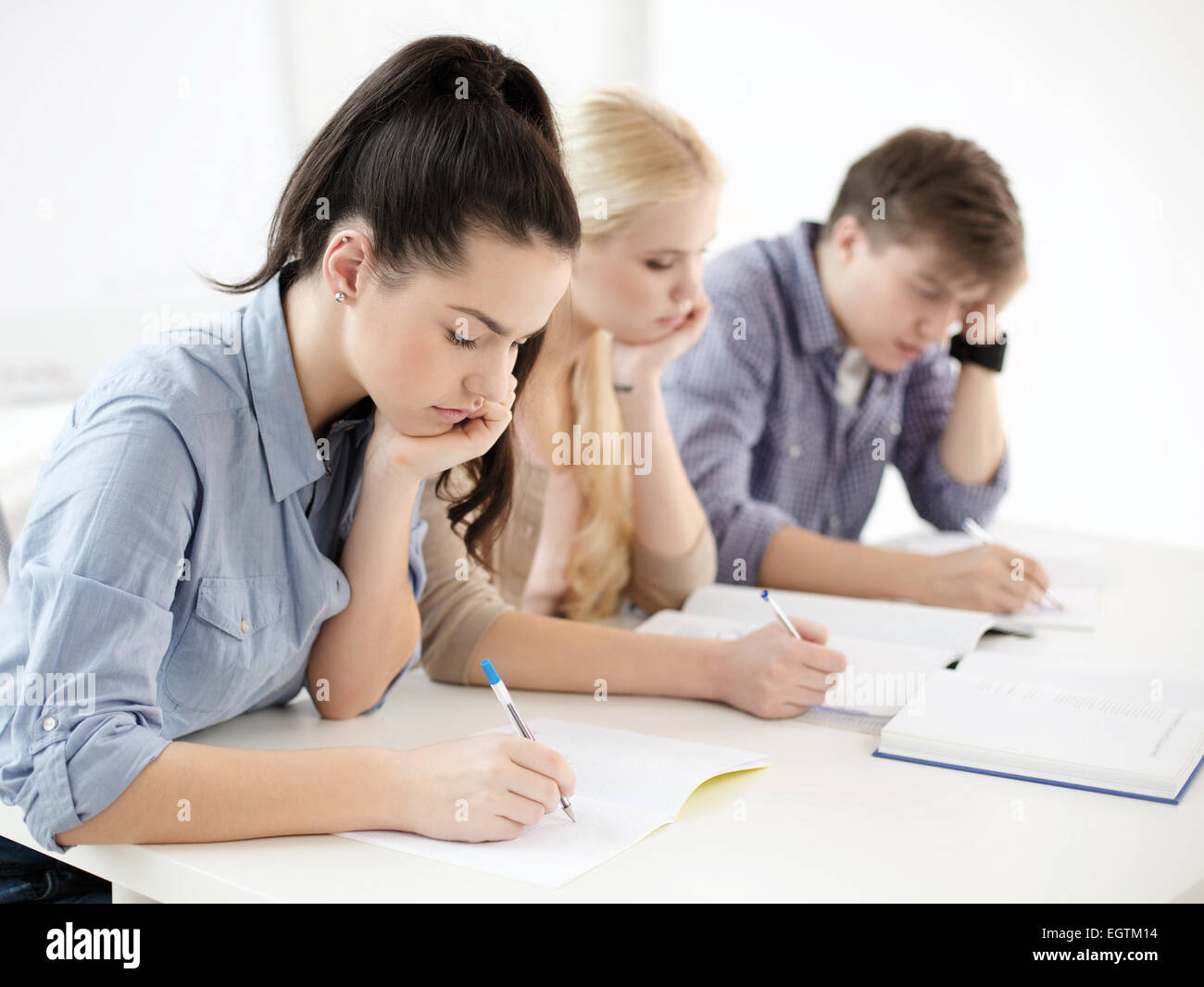 tired students with notebooks at school Stock Photo - Alamy