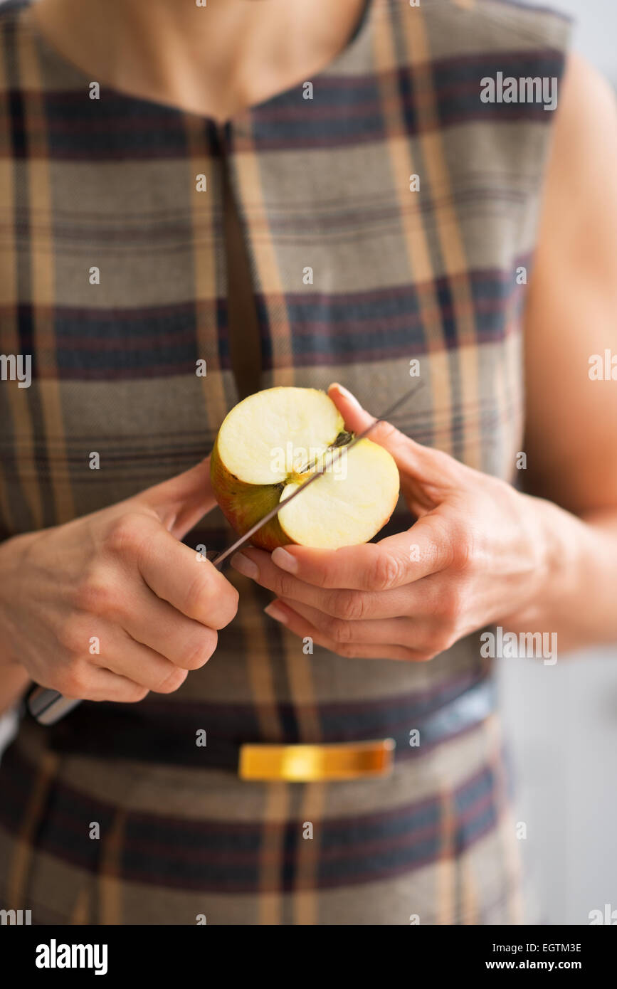 Closeup on young housewife cutting apple in kitchen Stock Photo - Alamy