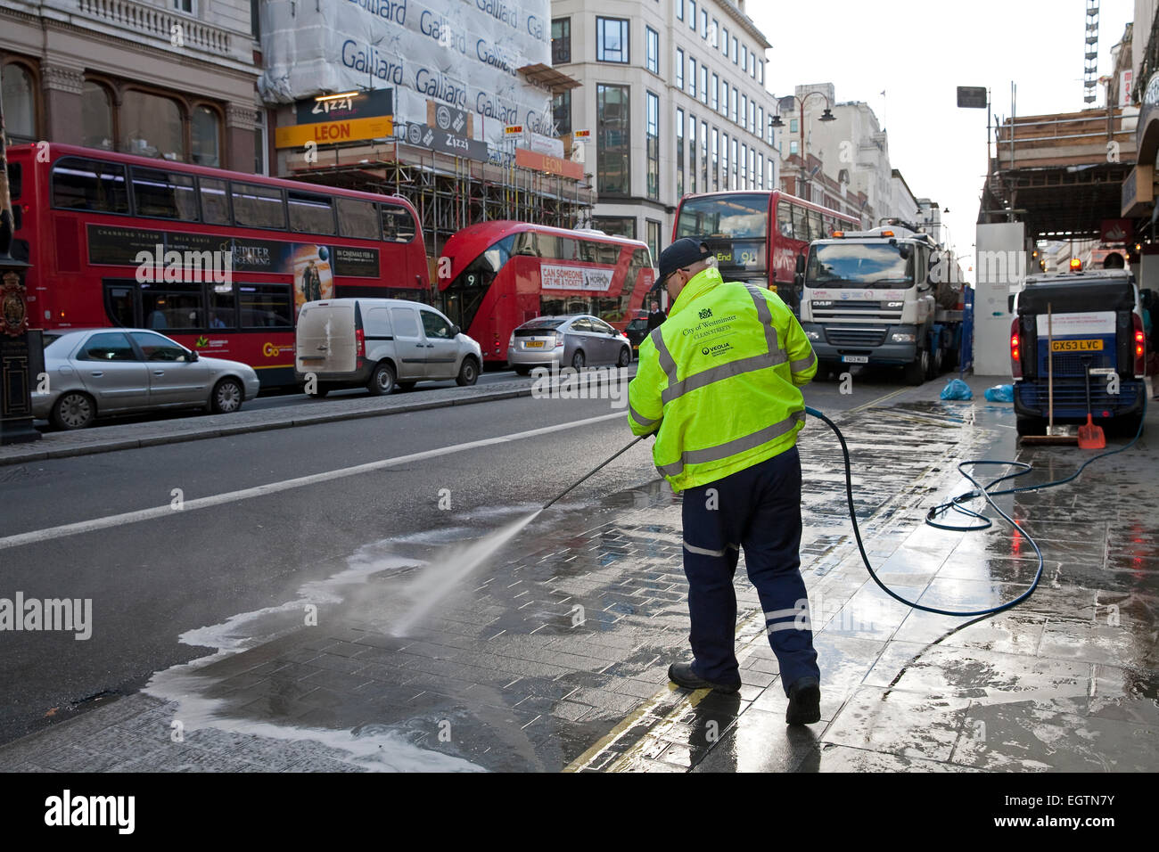 Street cleaning with a pressure hose outside the Vaudeville Theatre in ...