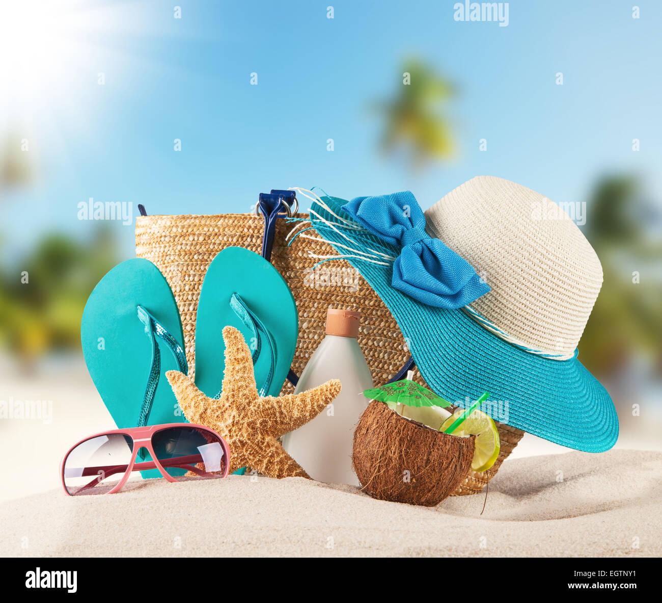 Summer concept with sandy beach, shells and blue sandals Stock Photo ...
