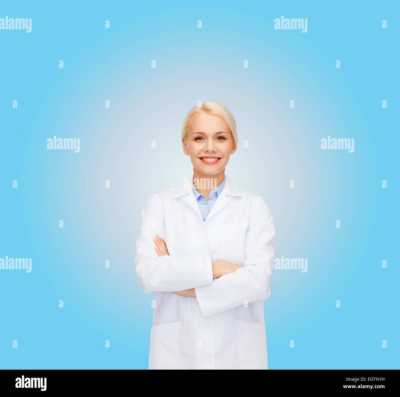 smiling female doctor over blue background Stock Photo - Alamy
