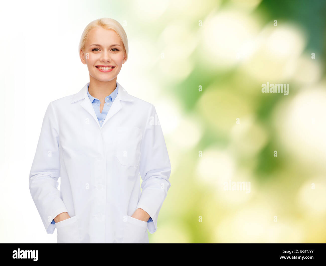 smiling female doctor over natural background Stock Photo - Alamy