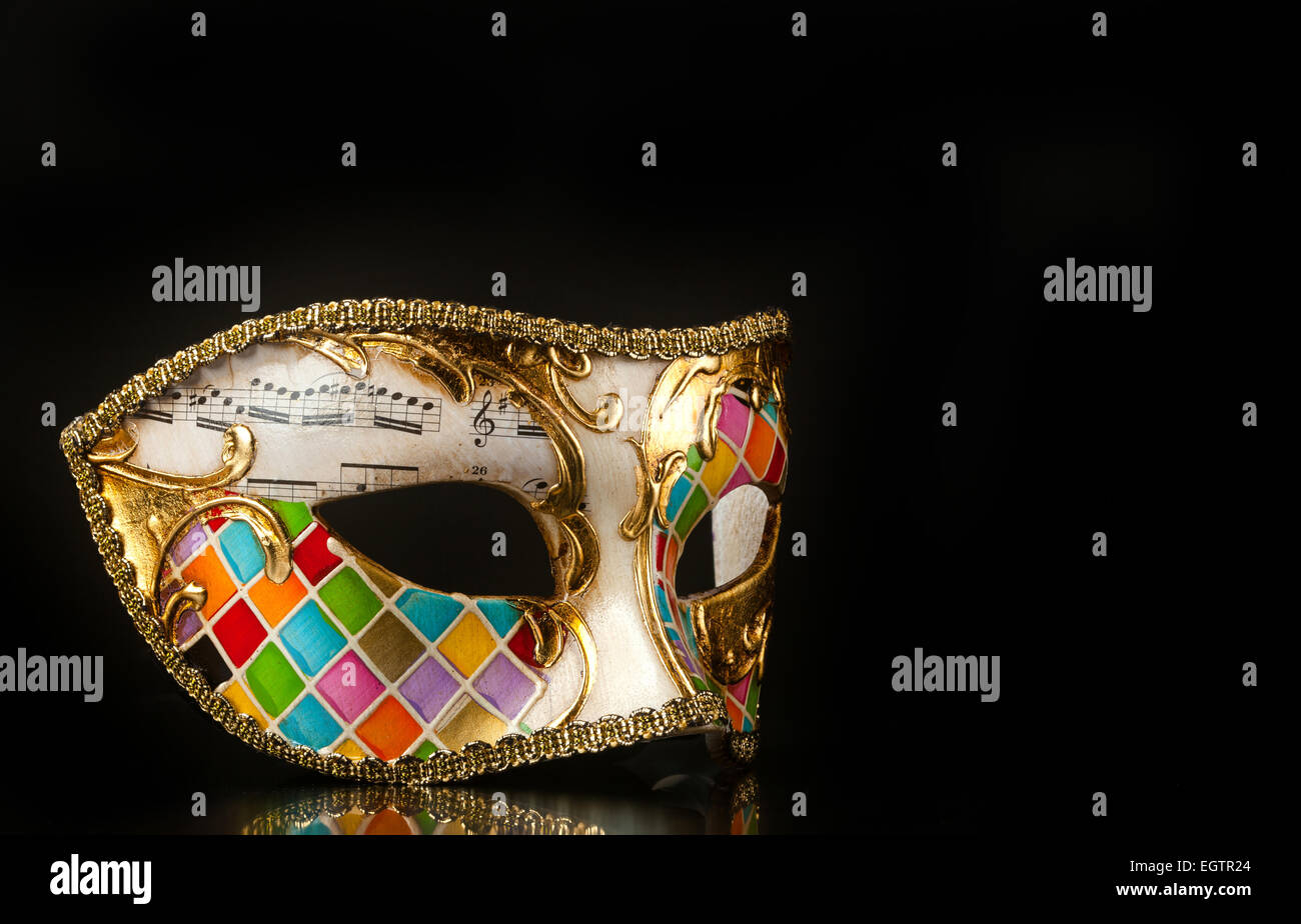Venetian mask harlequin style isolated on black background Stock Photo ...