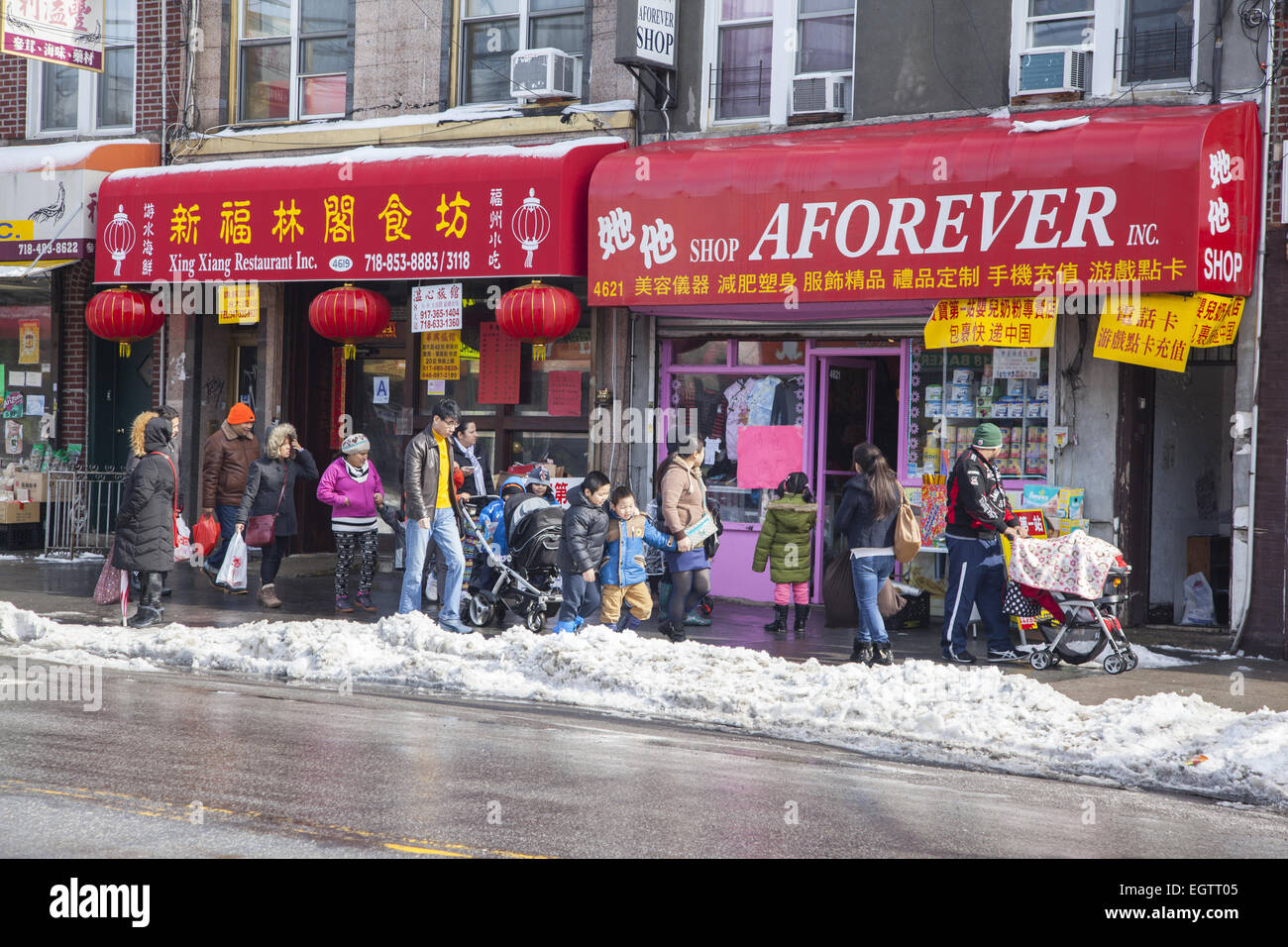 Local residents walk along 8th Avenue in the Chinatown neighborhood of Sunset Park, Brooklyn, NY ...