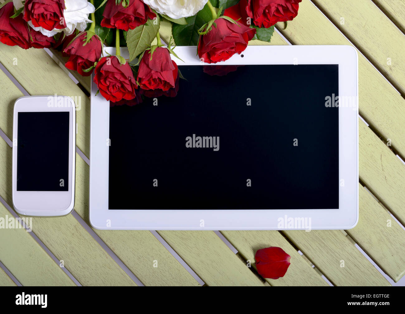 red roses with a tablet and phone Stock Photo - Alamy