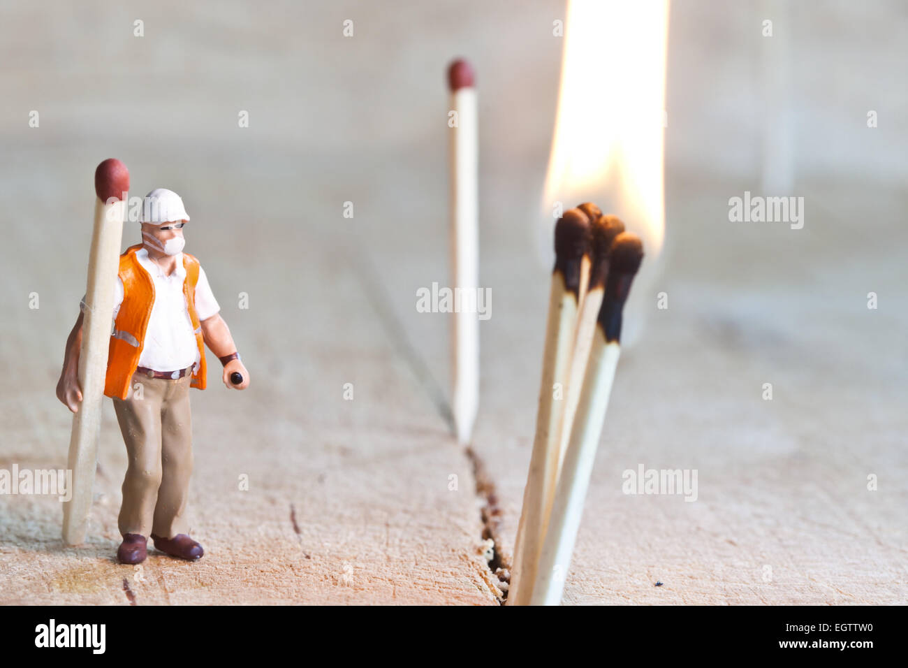 Miniature people with a matchstick Stock Photo - Alamy
