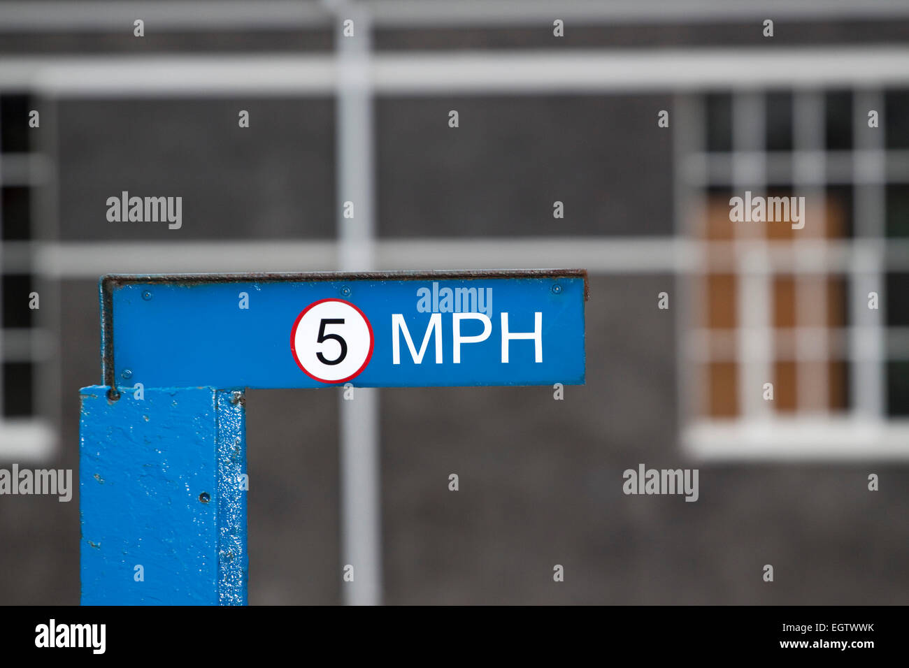 5 MPH speed limit warning on a blue metal post Stock Photo - Alamy