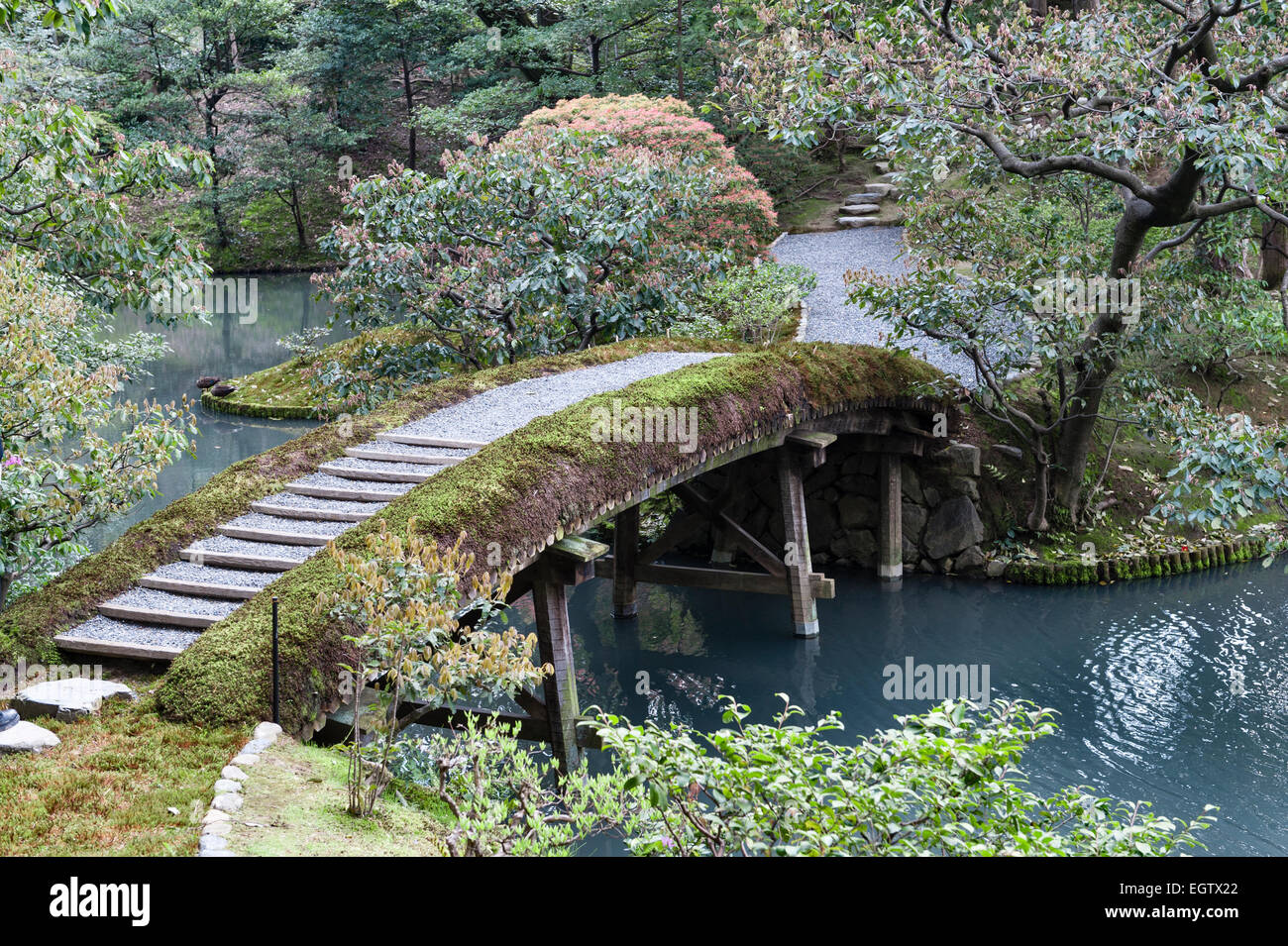 A moss-covered wooden bridge over the lake n the gardens of the Katsura ...