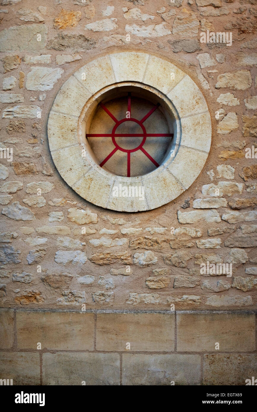 Unusual round window on a stone wall Stock Photo - Alamy