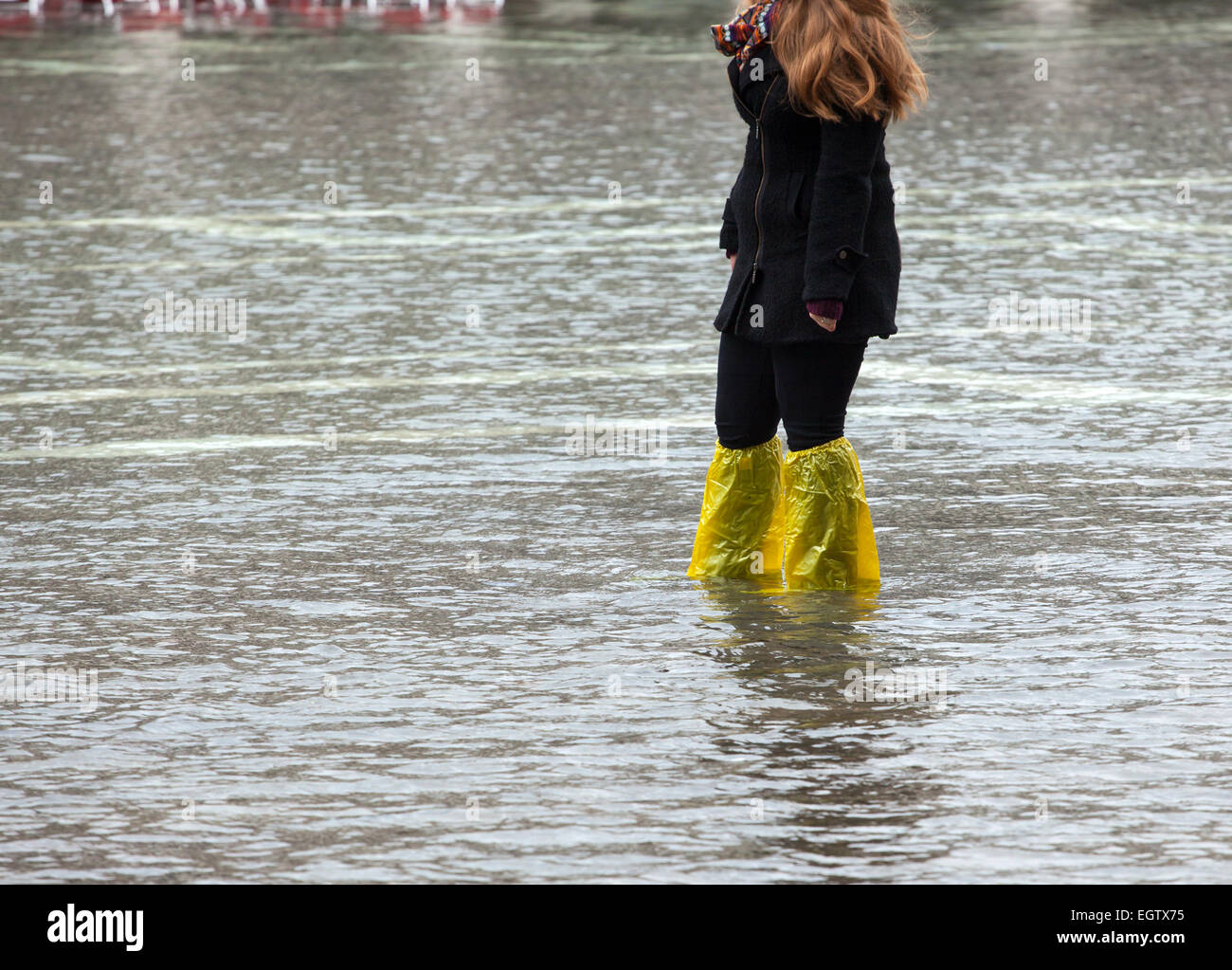Close Up of legs with boots due to the high water. This flood happens ...