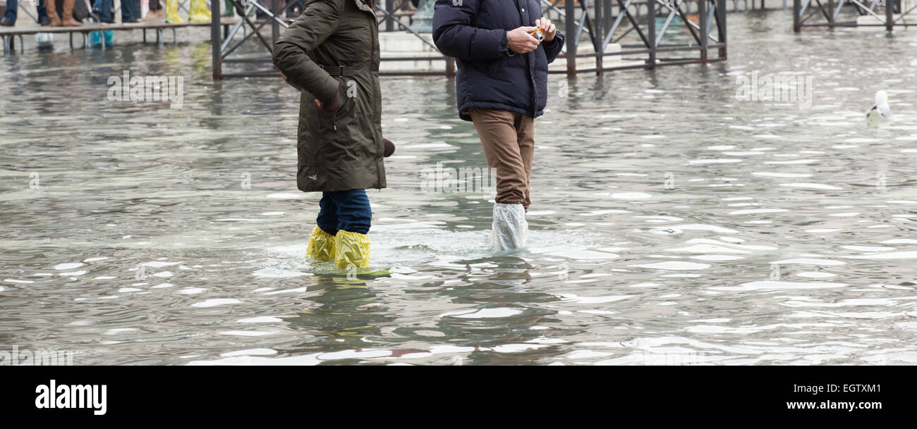 Close Up of legs with boots due to the high water. This flood happens ...