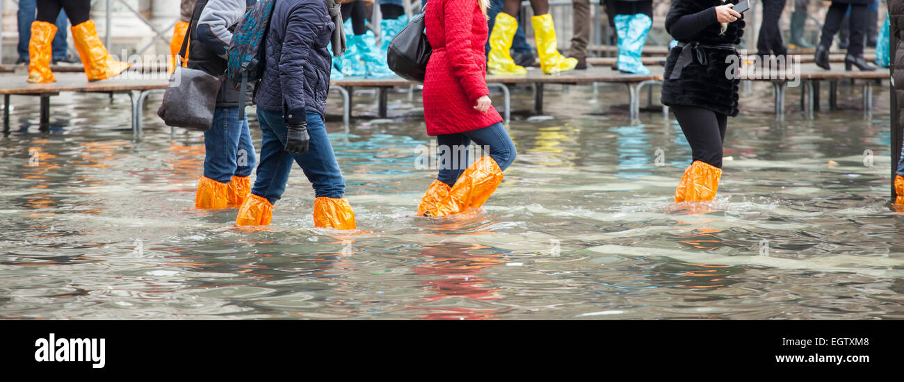 Close Up of legs with boots due to the high water. This flood happens ...