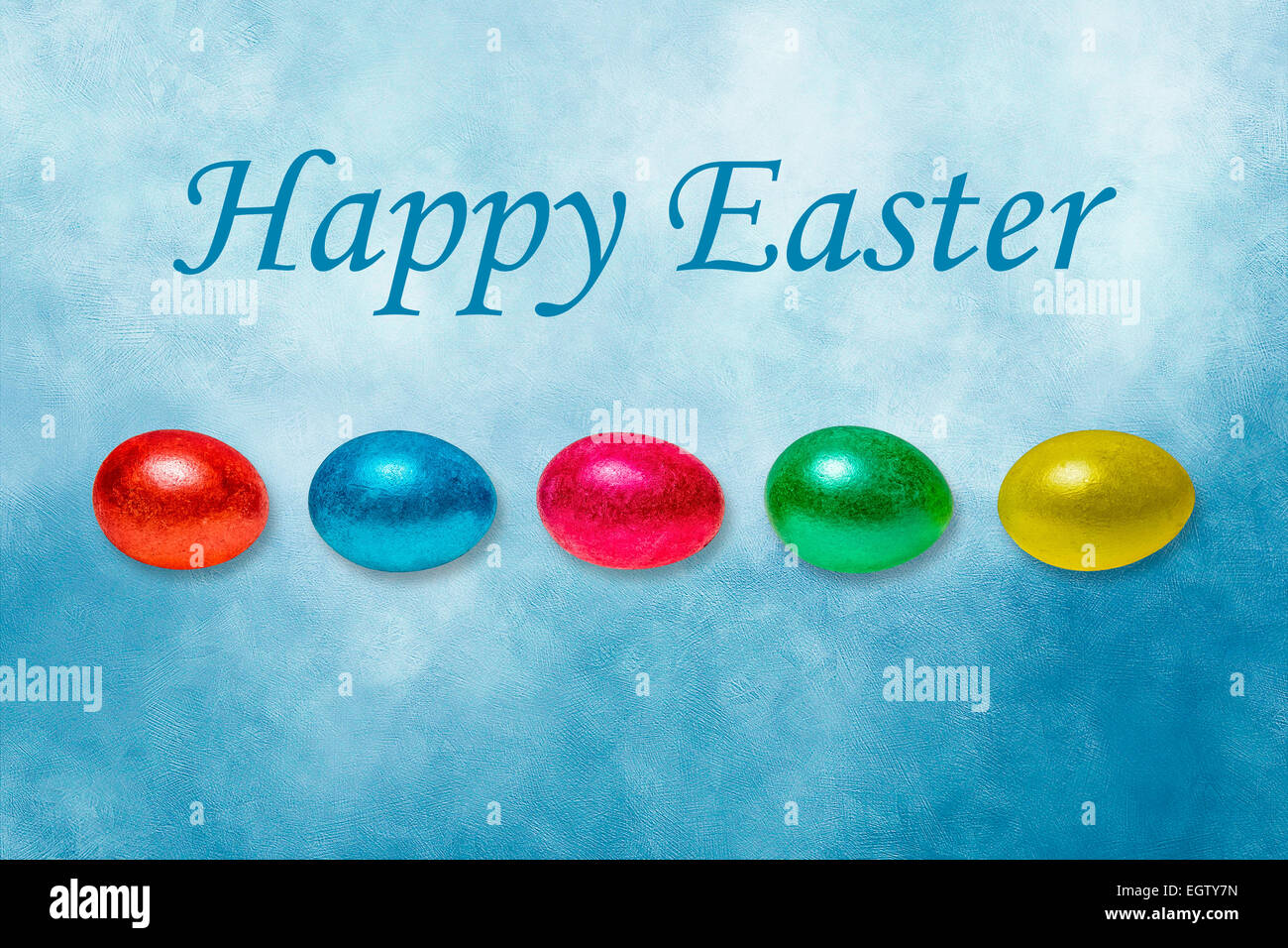 A line of colorful Easter eggs of red, blue, green, yellow and orange ...
