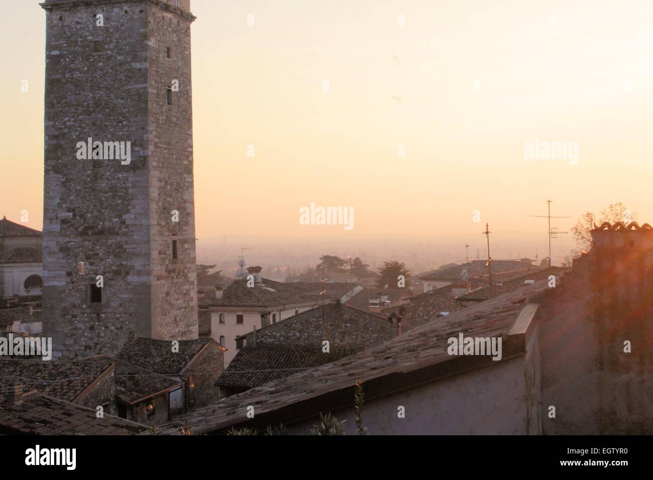 sunset over the rooftops of the village of Lonato in northern Italy ...