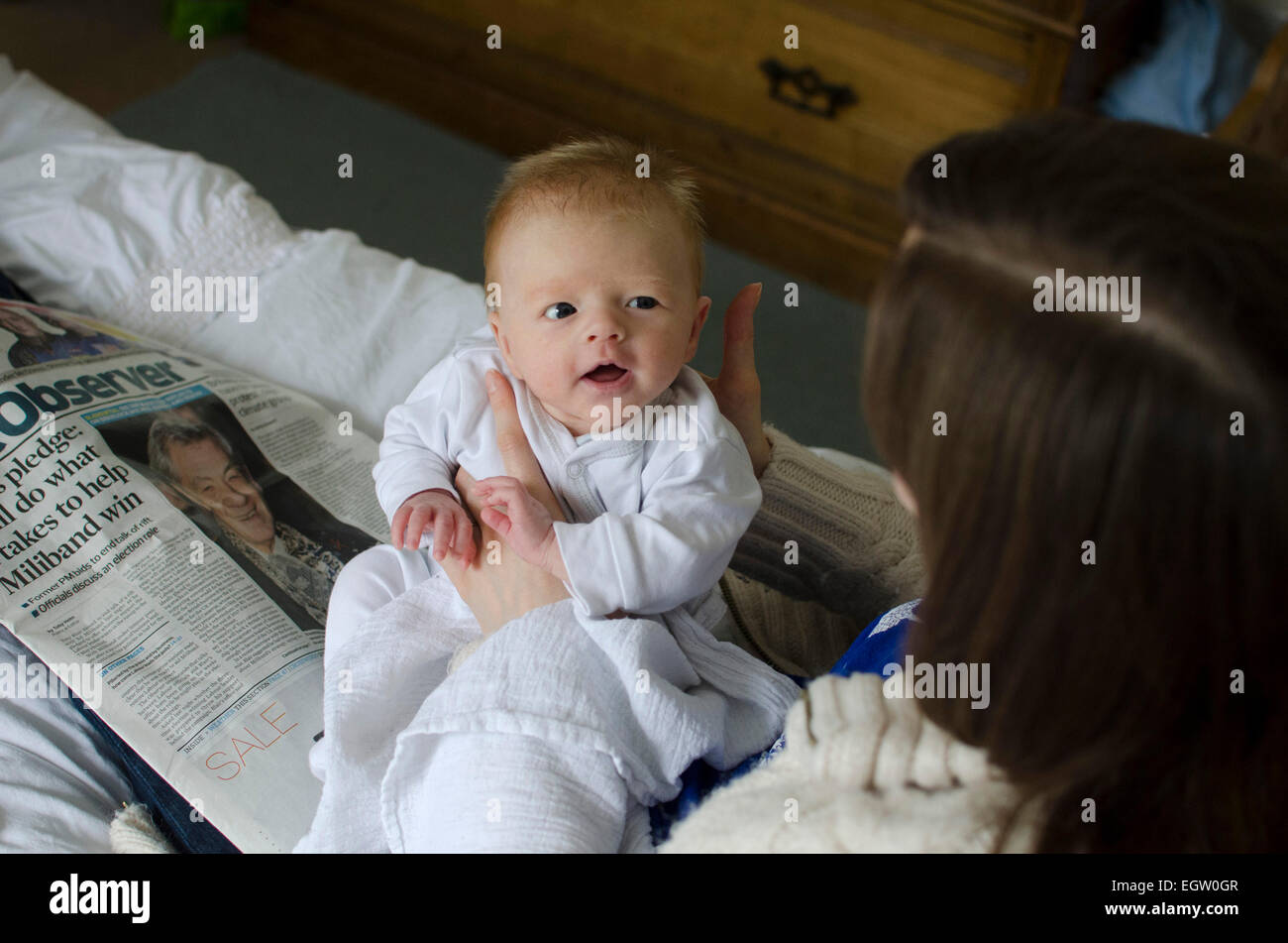A seven-week-old baby boy enjoying Sunday morning with his mother Stock ...