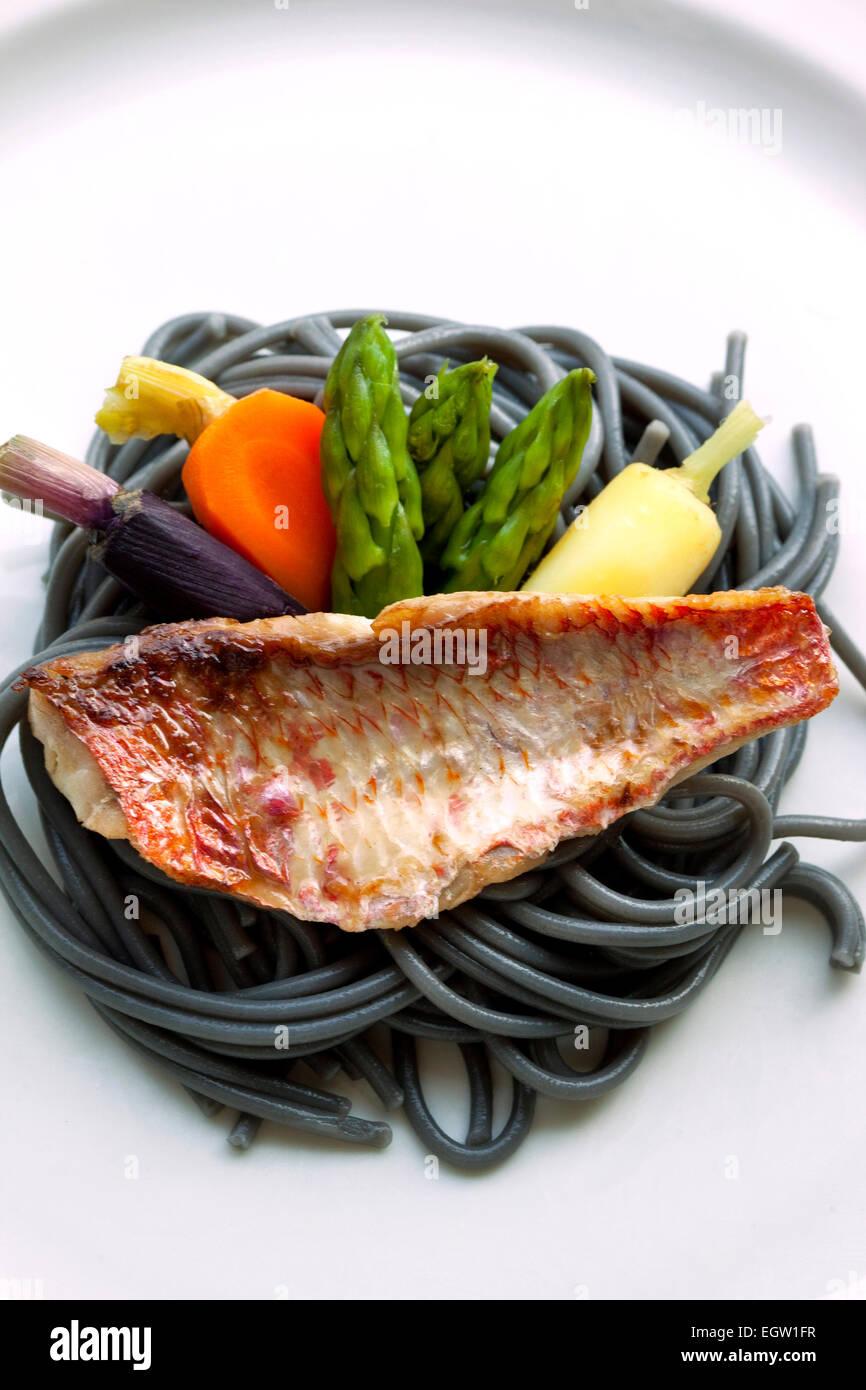 Red mullet fillet, vegetable and ink pasta Stock Photo - Alamy