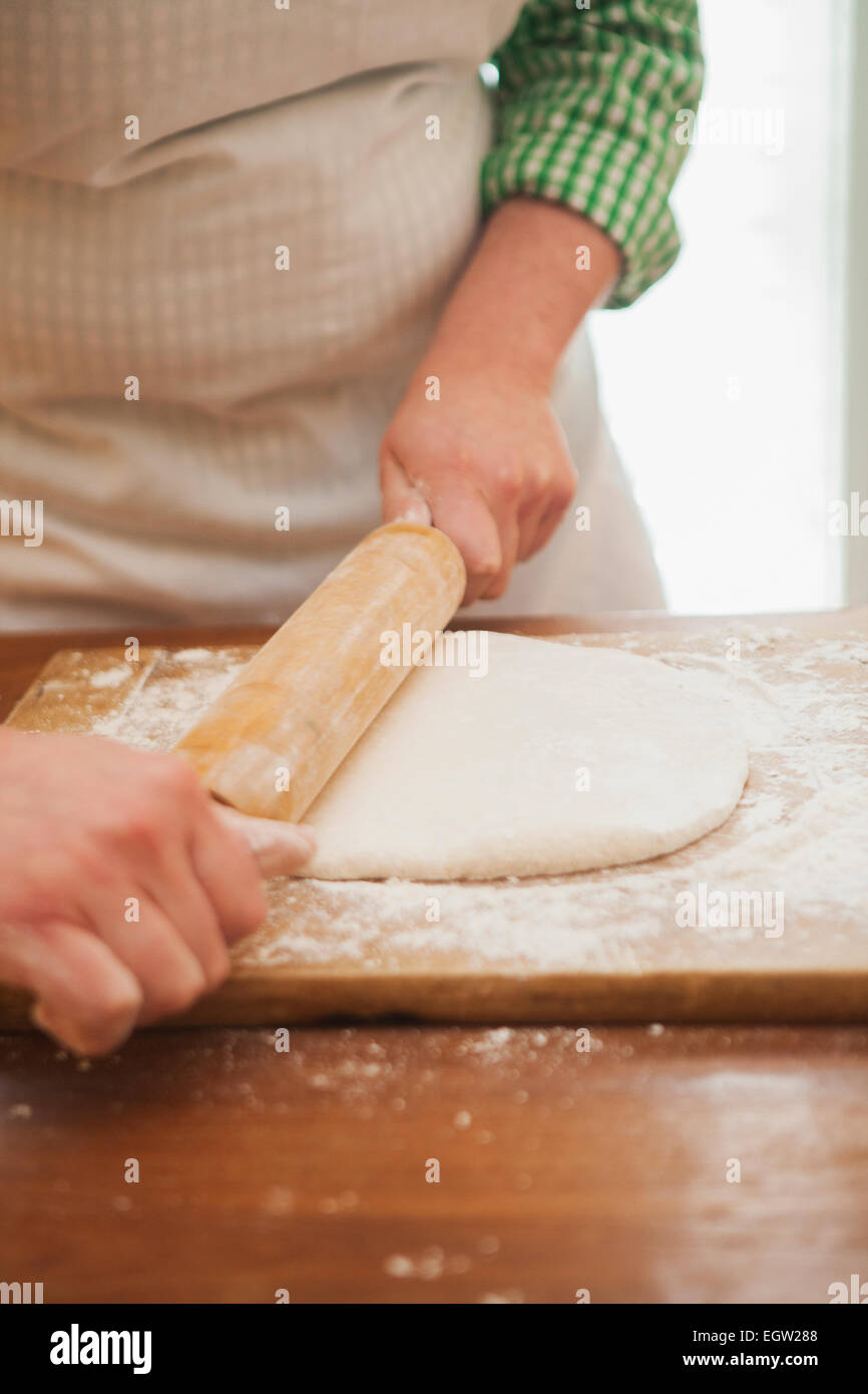 Woman rolling out dough Stock Photo - Alamy