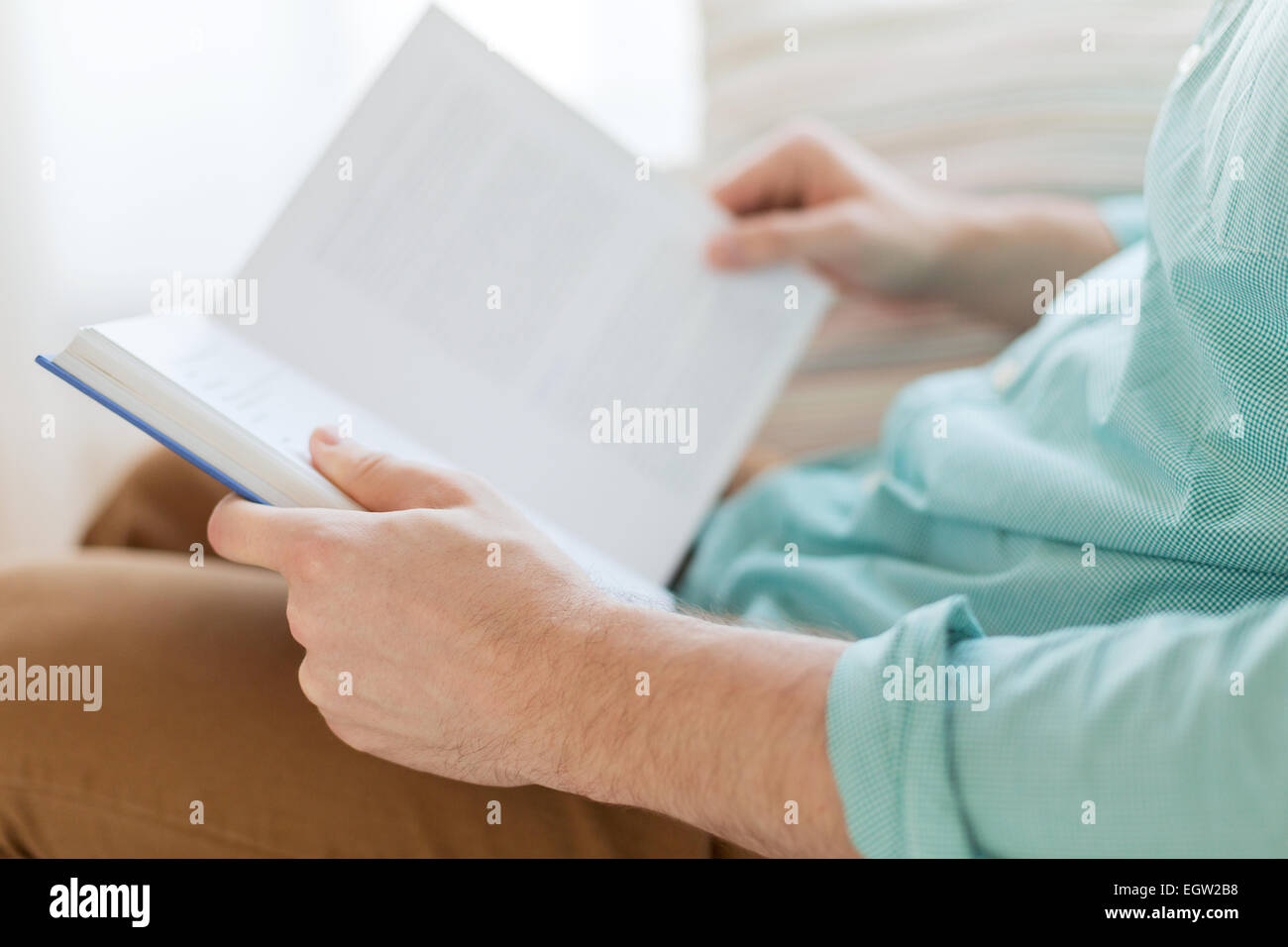 close up of man reading book at home Stock Photo - Alamy