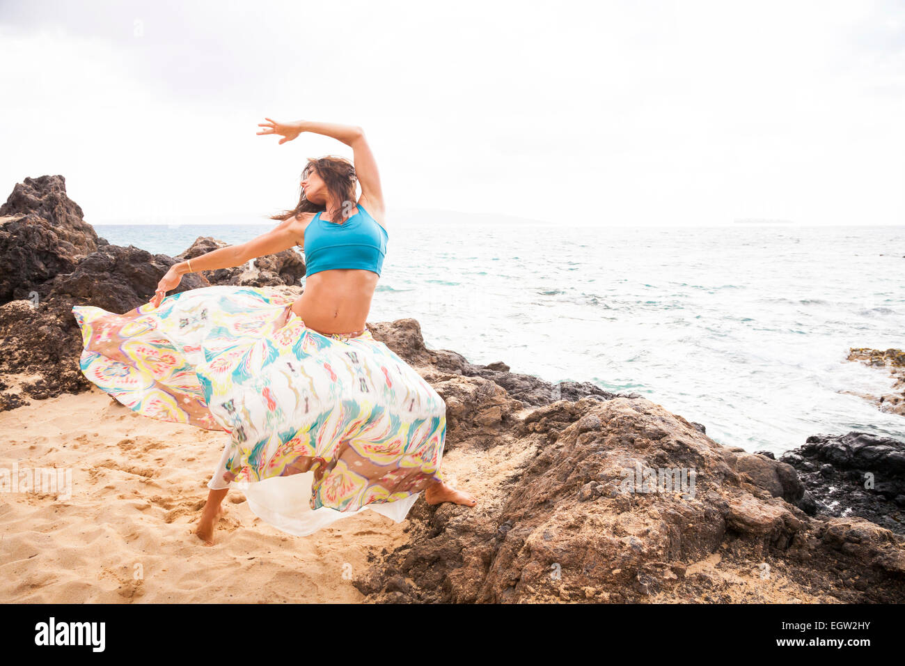 Woman dancing and jumping on beach Stock Photo - Alamy