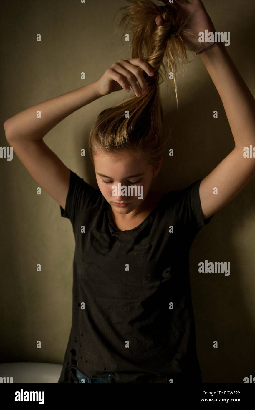 Teen girl fixing her hair Stock Photo - Alamy