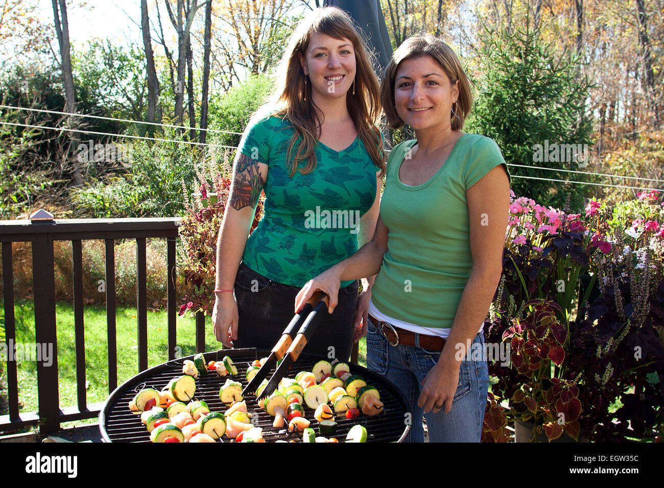 Two women grilling Stock Photo - Alamy