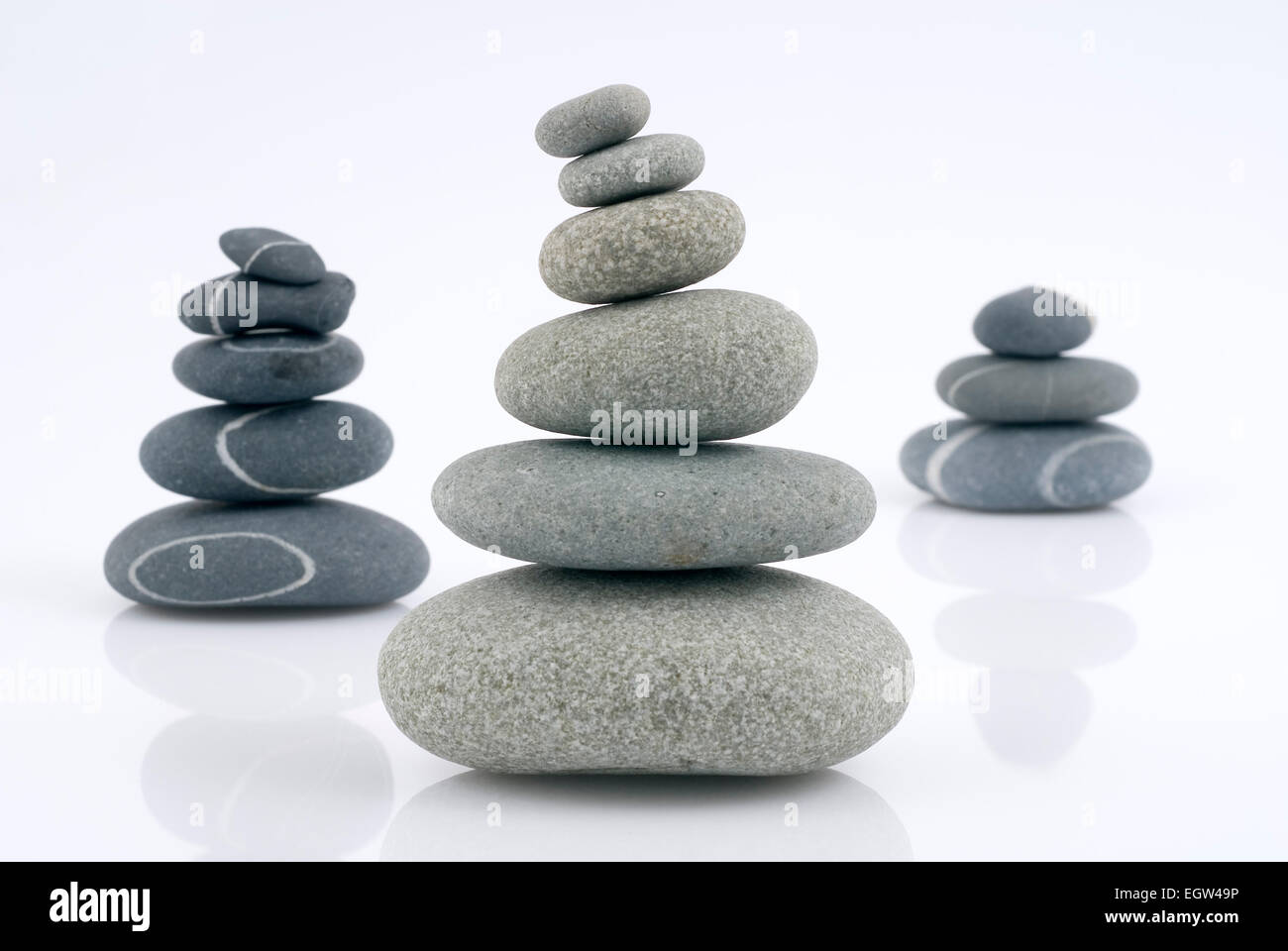 Three stone pyramids with six five and three stones stacked studio shot ...