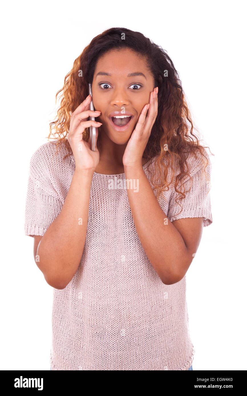 Ecstatic young African American woman making a phone call on her ...
