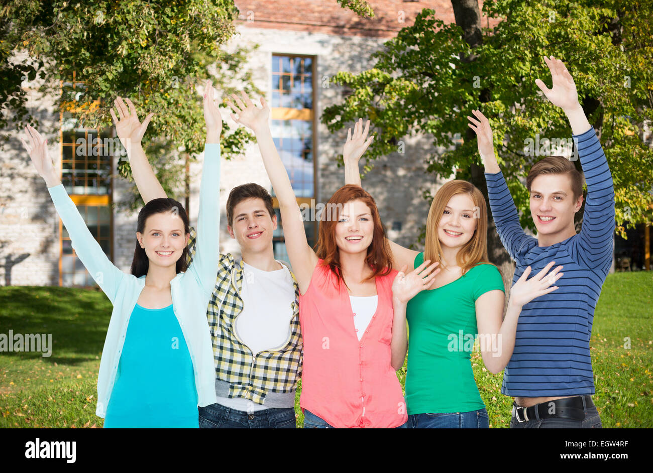 group of smiling students waving hands Stock Photo - Alamy