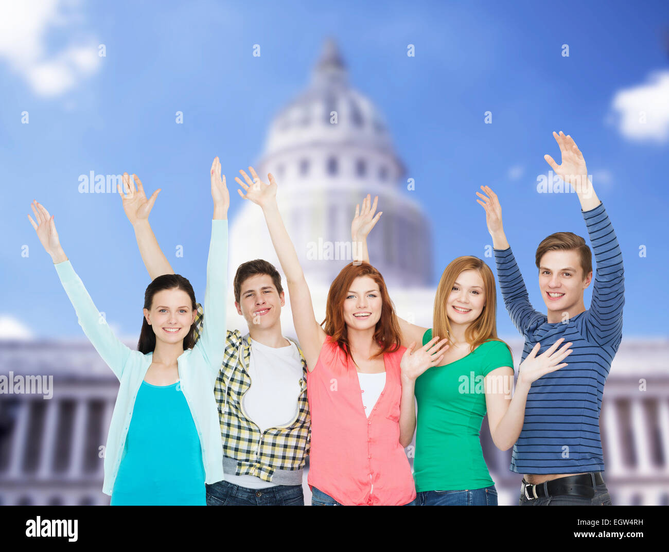 group of smiling students waving hands Stock Photo - Alamy